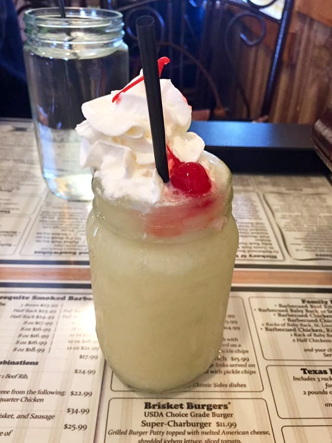 The piña colada arrives like a tropical vacation in a mason jar – whipped cream mountain included. Suddenly, you're on island time.