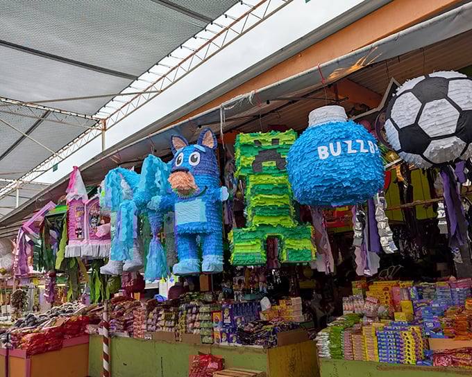 Piñatas that double as colorful suspended art. These festive creations hang like jubilant sentries, guarding aisles of candies and celebration supplies below.