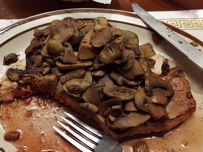 A porterhouse topped with sautéed mushrooms demonstrates why Hickory's reputation extends beyond barbecue into serious steak territory.