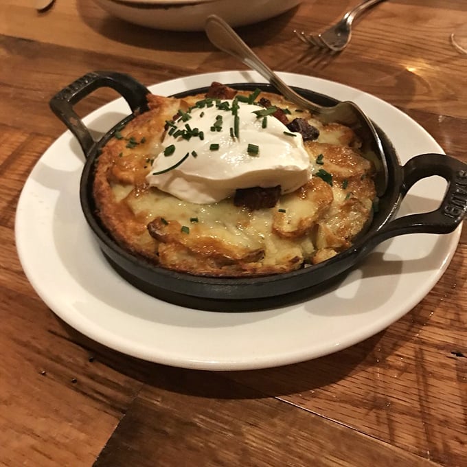 This isn't just a potato tart—it's a carb masterpiece with a supporting cast of perfectly caramelized onions and cheese.
