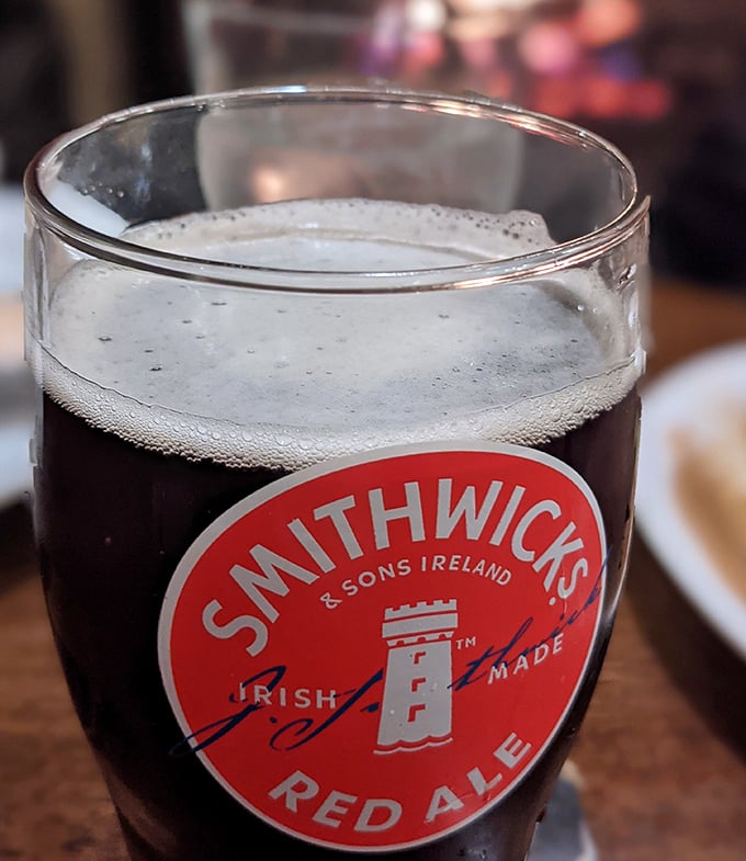 A perfectly poured Smithwick's Red Ale with its amber depths and creamy head – liquid history in a glass that's been making friends since 1710.