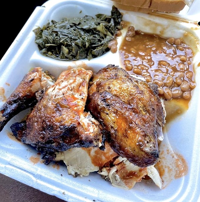 Chicken that's clearly been introduced to smoke and spice and decided to start a beautiful relationship. Those collards aren't just a side—they're a statement.