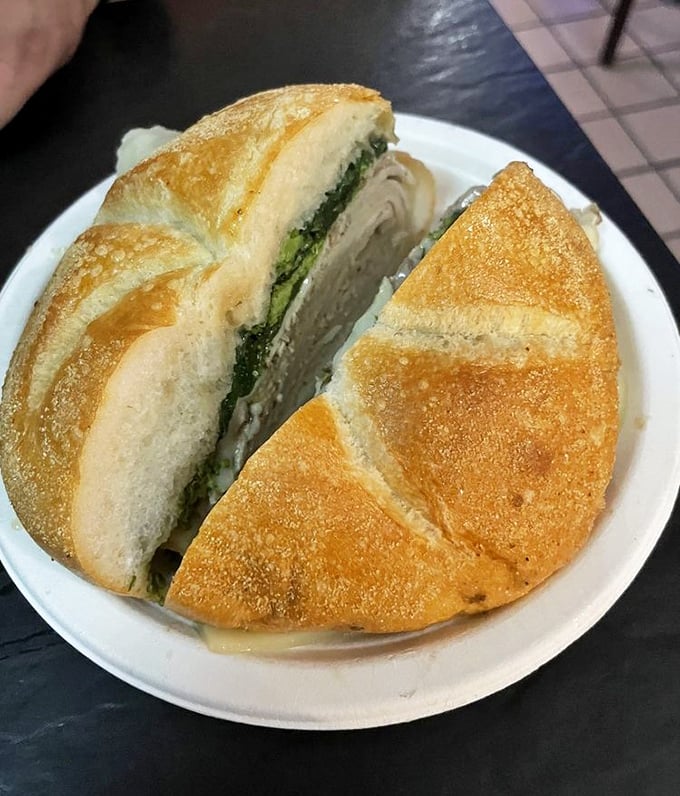When greens meet greatness. The bitter broccoli rabe creates a perfect counterpoint to the rich meat—a sandwich that understands balance.