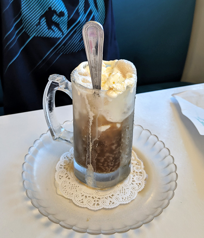 Root beer float served in a frosty mug with a proper spoon—proof that some pleasures never need upgrading.