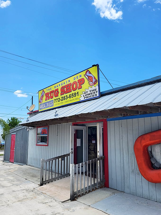 The Bargain Den Rug Shop promises "the lowest prices" beneath a cheerful crab sign—a perfect example of Florida's delightful retail eccentricity.