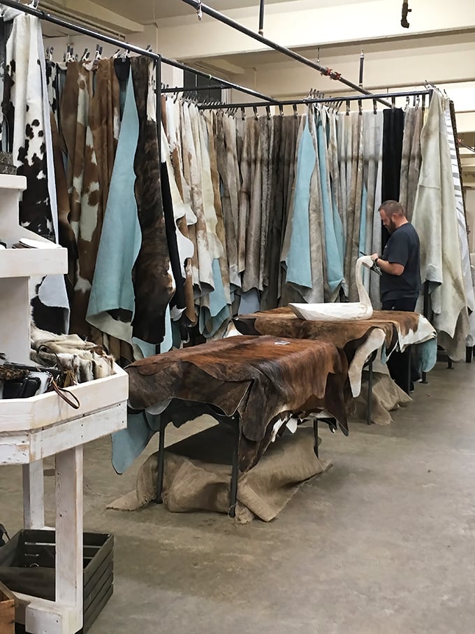 A leather lover's dream corner where cowhides and textiles hang like artwork. That perfect statement piece for your rustic-chic living room is hiding here.