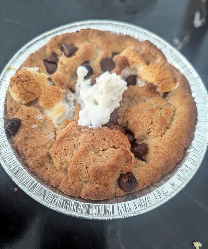 This isn't just dessert—it's a warm chocolate chip cookie topped with ice cream that's melting into all the right places. Resistance is futile.