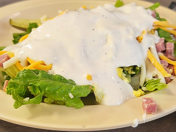 Even the salad gets the Southern treatment—cheese, ham, and enough ranch dressing to make a dietitian clutch their pearls in horror.