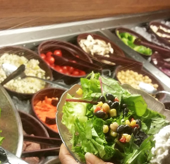 The salad bar's colorful bounty offers a fresh prelude to seafood indulgence – a rainbow of vegetables standing at attention.