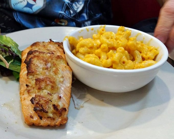 Perfectly seared salmon keeping unexpected company with mac and cheese—a friendship we didn't know we needed until now.