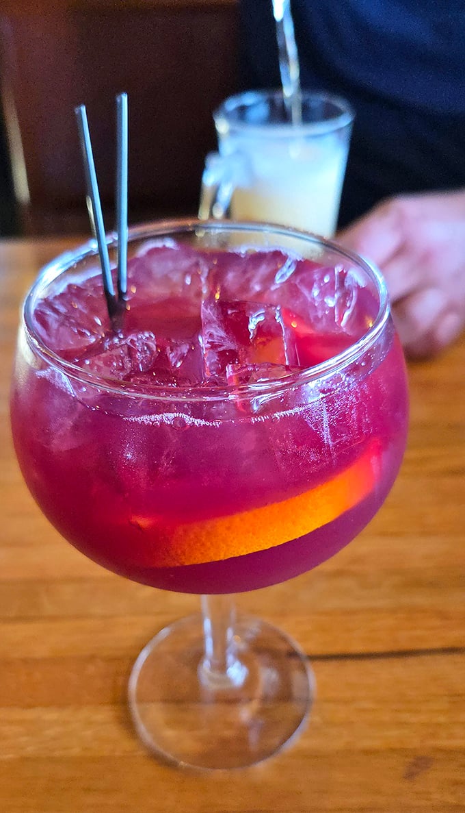 A ruby-red sangria that's dressed better than most people at formal events, garnished with citrus and promising fruity refreshment.