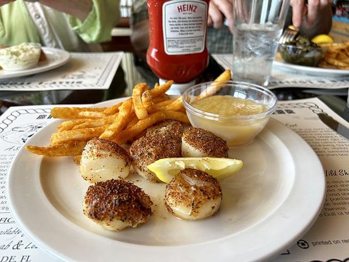 Perfectly seared scallops with golden fries – ocean candy that makes you wonder why people bother with regular candy.