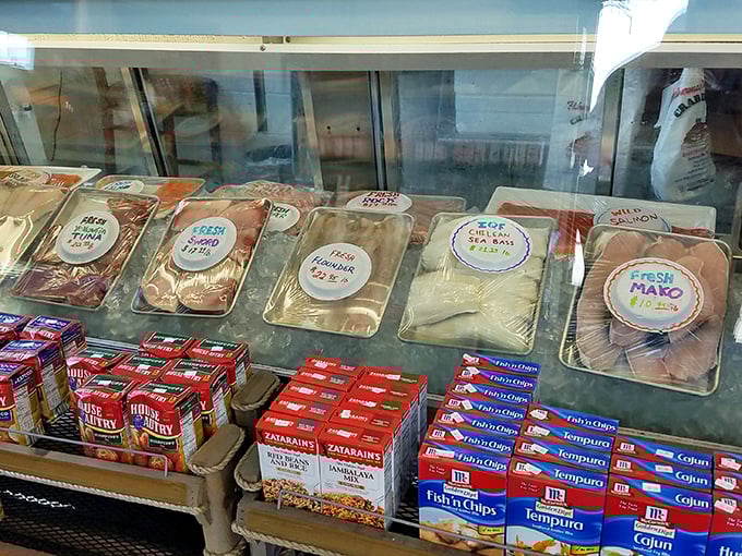 Behind glass, fresh catches await their destiny—a seafood display that makes grocery store seafood counters hang their heads in shame.