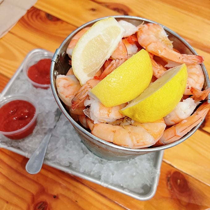 The shrimp cocktail that means business—plump crustaceans arranged around lemon wedges like synchronized swimmers taking a bow.