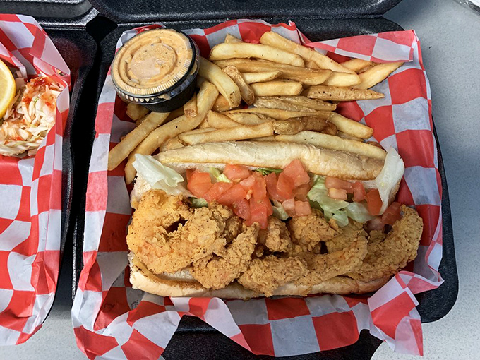 The shrimp po' boy that could convert vegetarians – overstuffed, unapologetic, and dressed to the nines with crispy companions.