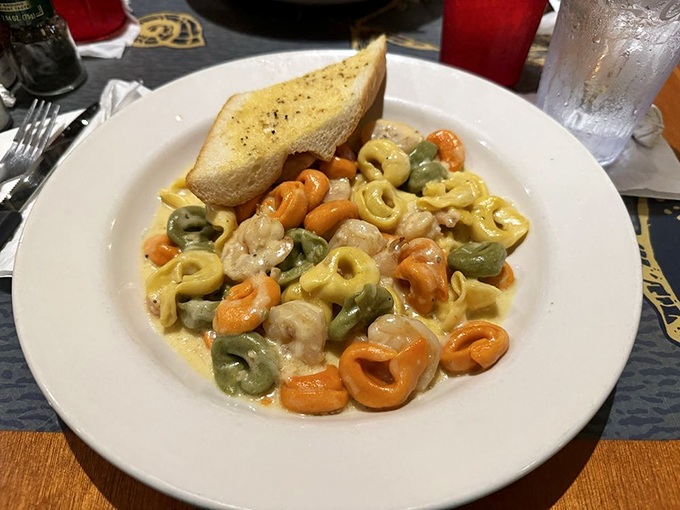 Tri-colored tortellini swimming in a creamy sauce with shrimp – pasta that's dressed for a fancy occasion but keeps the conversation casual.