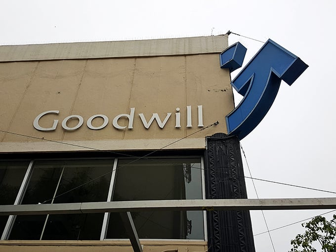 The iconic Goodwill smile logo reminds shoppers that their purchases support job training programs—retail therapy that actually provides therapy to others.