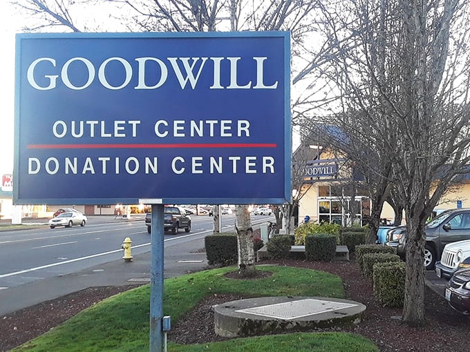 The roadside beacon that guides bargain hunters to their happy place. Both "Outlet" and "Donation" on one sign—the perfect circle of sustainable shopping.