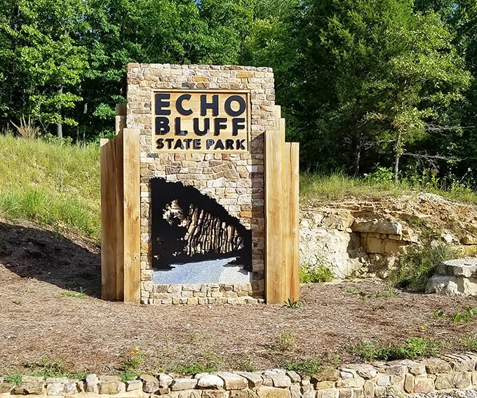 The park entrance sign offers a stone-framed preview of the natural wonders waiting just beyond—like a trailer for Earth's greatest hits.