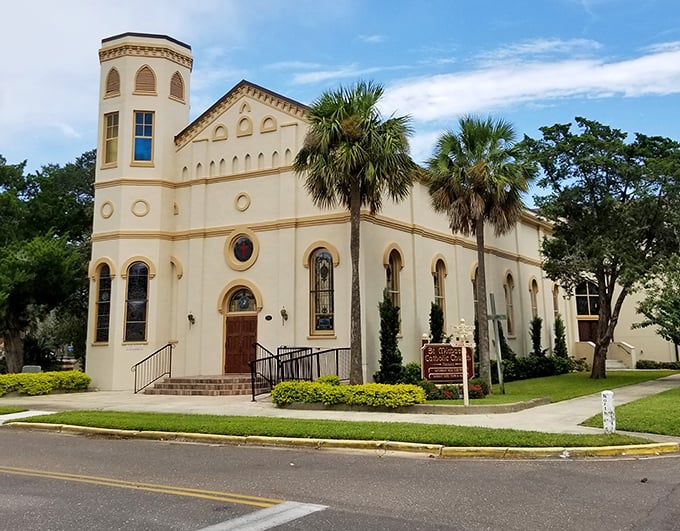 St. Michael Catholic Church stands like a pale sentinel against the blue Florida sky, its Mediterranean style a nod to the island's Spanish heritage.