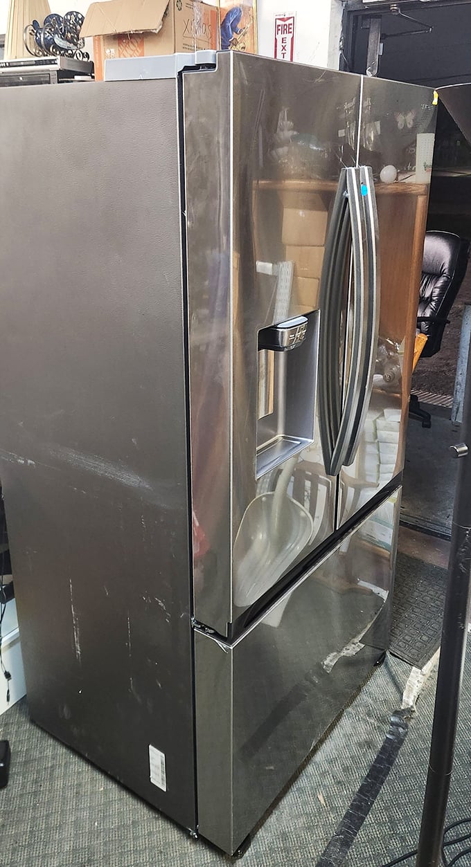 A stainless steel refrigerator waiting for its second act—perfect for the garage beer fridge or storing enough food for hurricane season.