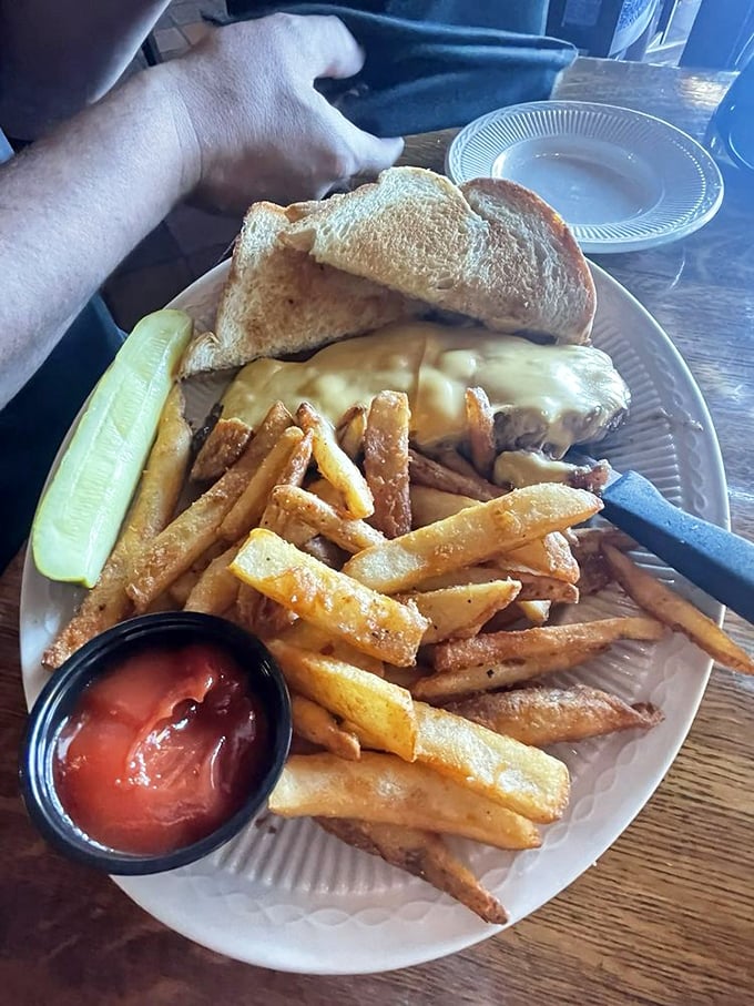 The steak sandwich—where prime beef meets melted cheese in a handheld masterpiece. Paired with fries so crisp they deserve their own sound effect.