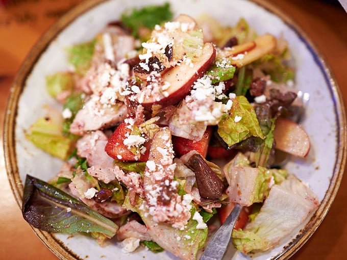 A salad that doesn't apologize for being delicious. Fresh greens, fruit, and cheese prove that "healthy option" doesn't mean "flavor sacrifice."