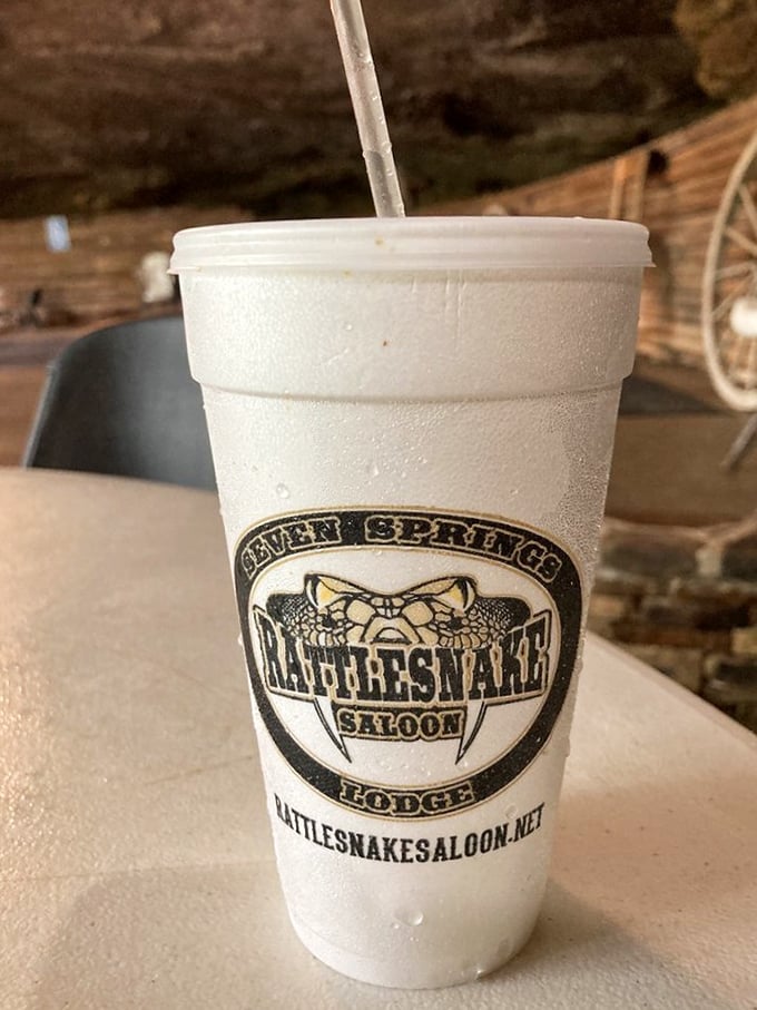 The logo-emblazoned cup isn't just holding sweet tea—it's containing liquid Southern hospitality that somehow tastes better when sipped beneath ancient stone.