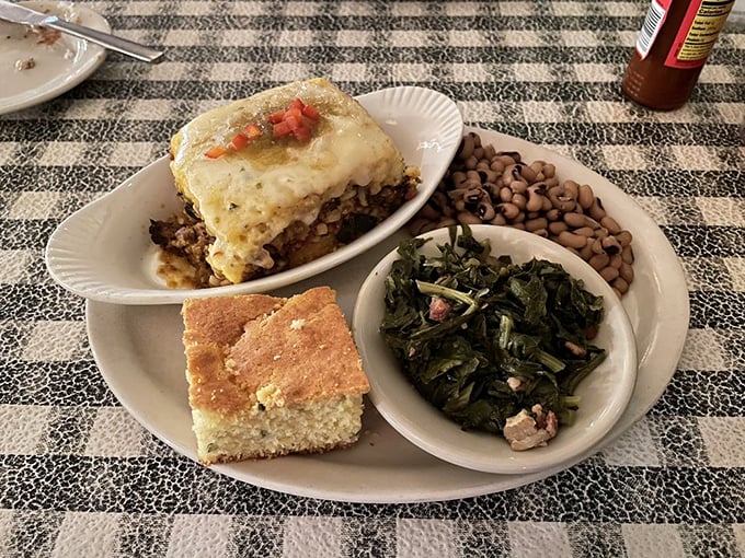 A Southern plate that tells a story with every bite – collard greens, black-eyed peas, and cornbread forming the perfect supporting cast.