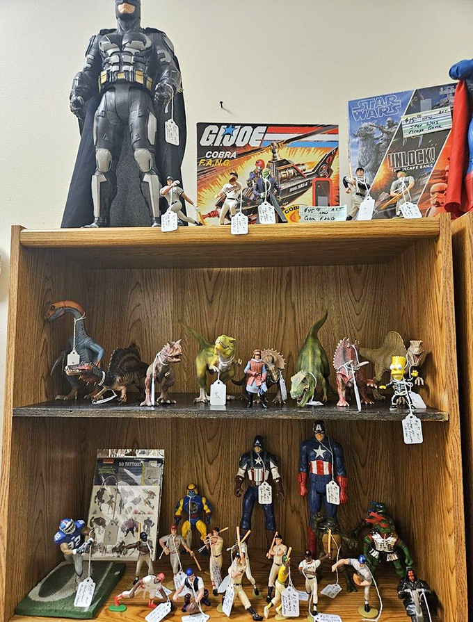 Superhero figures stand guard over dinosaurs and action heroes. Batman doesn't seem concerned about sharing shelf space with Captain America—a crossover we all wanted!