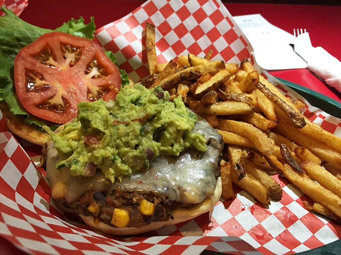 A burger topped with guacamole that makes you want to high-five the chef and then ask for the recipe you'll never actually use.