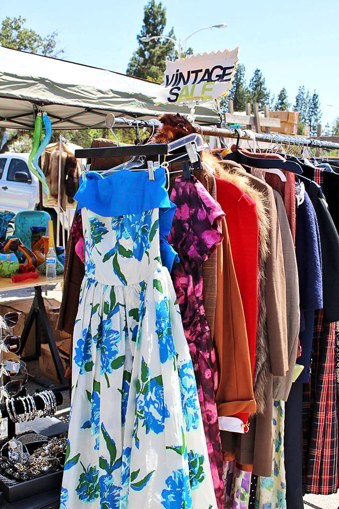 Fashion time travel on a single rack. That blue floral dress isn't vintage – it's a portal to summers of decades past.