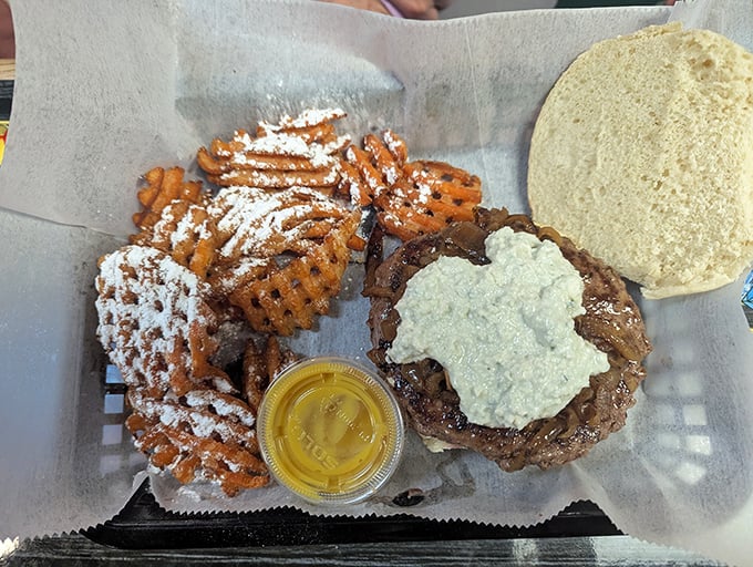 Waffle fries dusted with powdered sugar alongside a burger topped with what appears to be blue cheese – Jeff's isn't afraid to play with contrasting flavors.