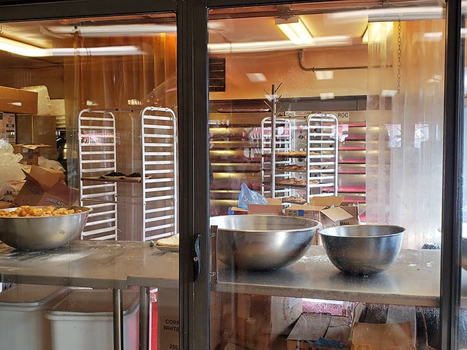 A glimpse behind the magic curtain. Those baking racks aren't just equipment—they're the launching pads for dreams made of butter and flour.