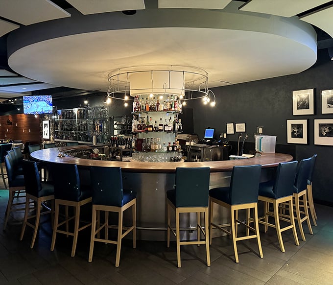 The circular bar isn't just where drinks are served—it's where strangers become friends and "just one more" becomes the evening's mantra.