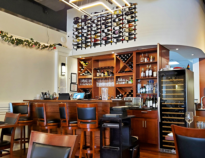 The bar isn't just stocked—it's curated, with a wine wall that makes selecting your bottle feel like choosing from a liquid library.