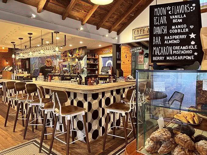 The bar area combines vintage charm with modern flair—note the playful black and white tile pattern that somehow works perfectly with the rustic wooden ceiling.