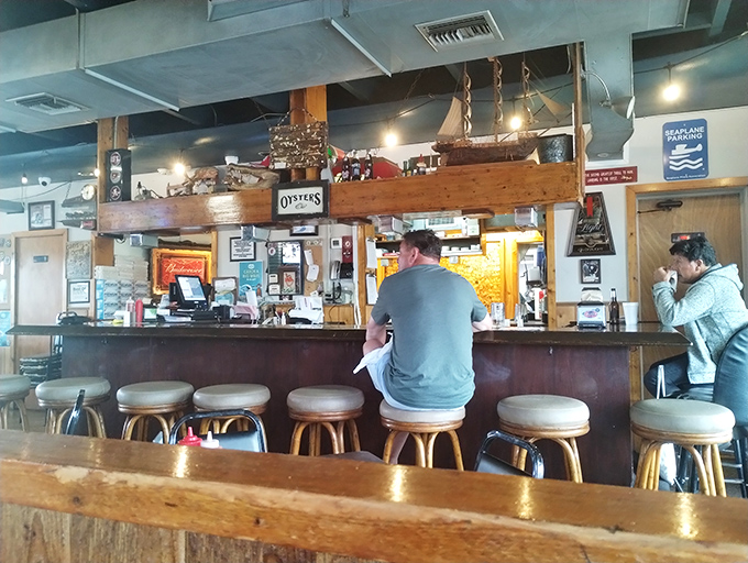 The bar area—where oyster wisdom is dispensed freely, and regulars have claimed their stools through years of devoted patronage.