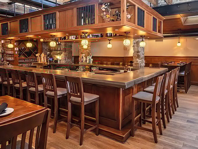 The bar area combines rustic stone, polished wood, and pendant lighting to create the perfect backdrop for both serious conversations and spontaneous laughter.