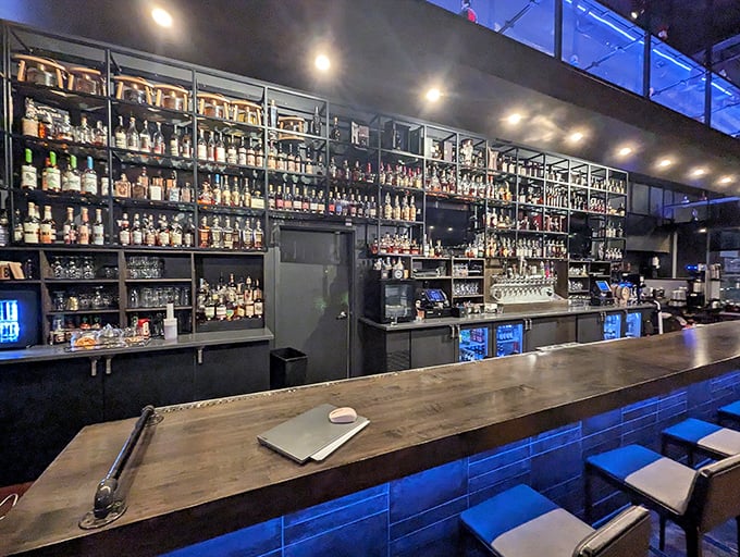The Great Wall of Bourbon. This isn't just a bar—it's a library of Kentucky's finest spirits illuminated by the soft blue glow of possibility.