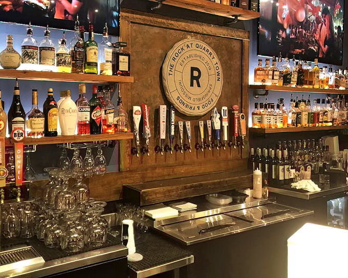 The bar at The Rock doesn't just serve drinks—it showcases them like the liquid treasures they are, all wood, warmth, and welcome.