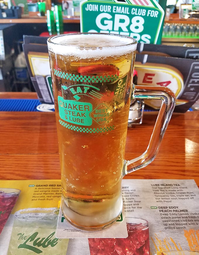 This isn't just a beer—it's a golden chalice of refreshment in a branded mug that makes everything taste better, especially after those Triple Atomic wings.