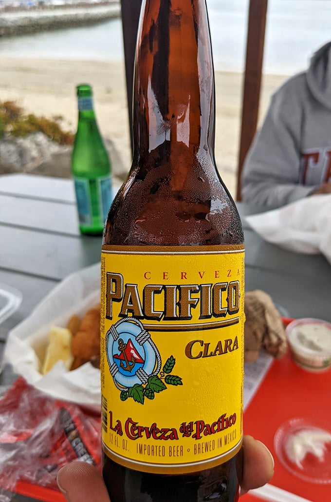 Cold beer with a view—because sometimes the perfect pairing for fresh seafood isn't wine, but a crisp Pacifico with the ocean breeze as garnish.