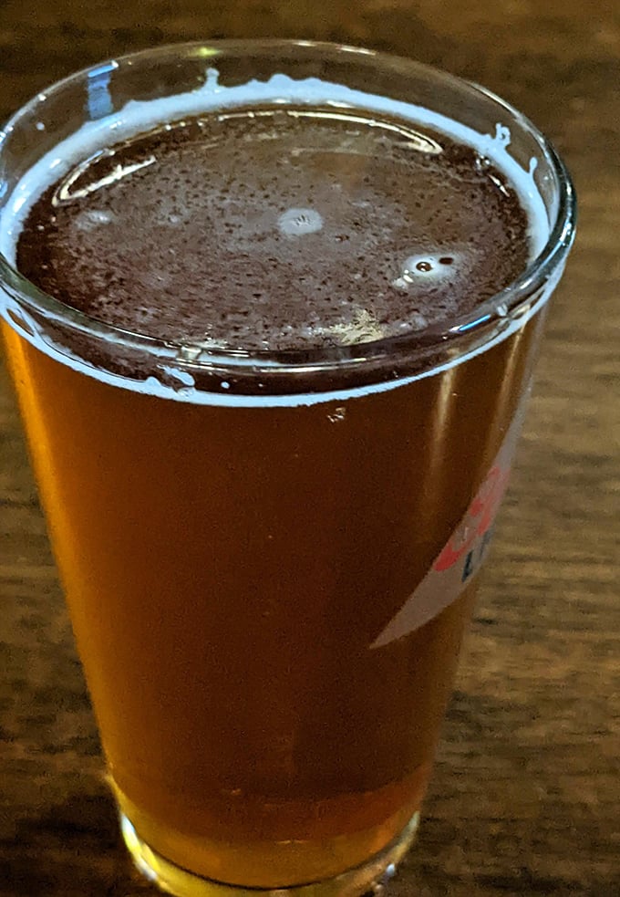 Amber perfection in a glass. The light catches this perfectly poured pint, promising refreshment with depth of character—just like the pub itself.