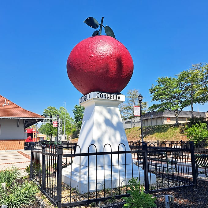 From this angle, the Big Red Apple looks ready to star in its own superhero movie—"Captain Cornelia: The First Avenger Fruit."