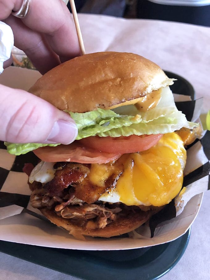 The ultimate power move: pulled pork topped with cheese, bacon, and a fried egg. This isn't just a sandwich—it's a commitment to excellence.