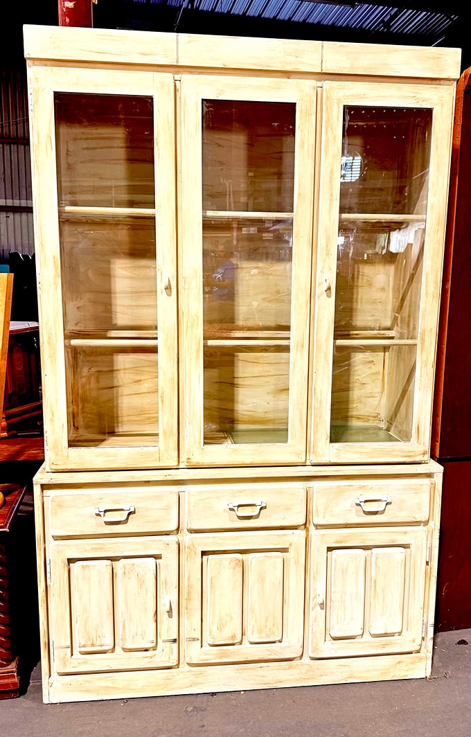 A shabby-chic hutch stands proudly, its distressed finish not hiding imperfections but celebrating a life well-lived and ready for more.