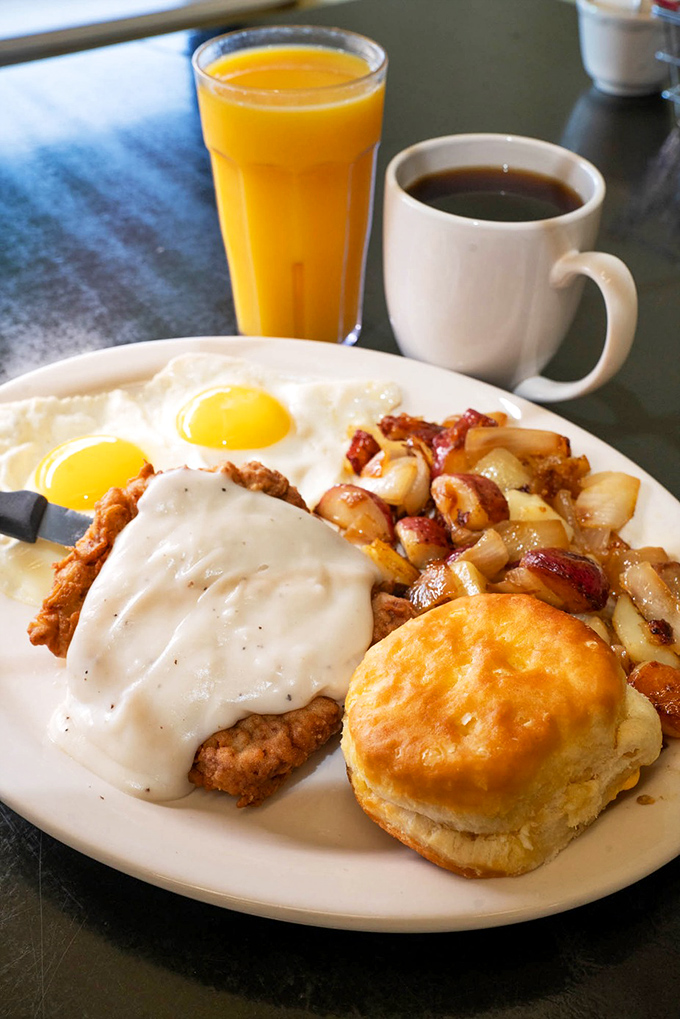Country-fried steak with gravy, eggs, potatoes, and that signature biscuit—a breakfast plate that requires both commitment and stretchy pants.