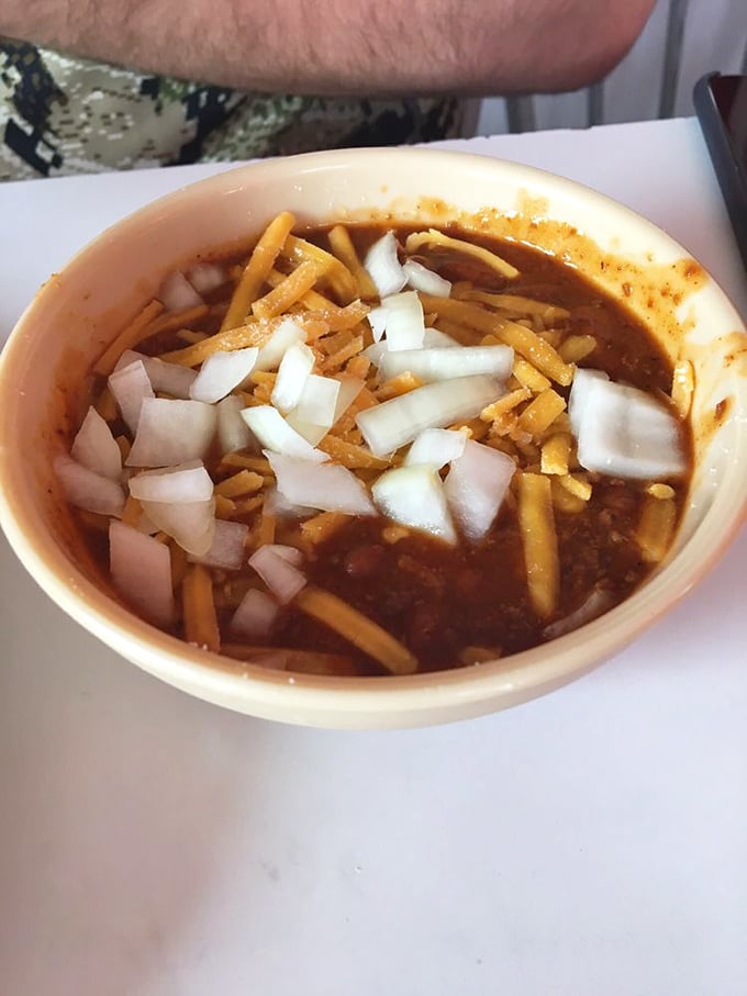 Chili topped with the dairy-onion crown it deserves. This bowl doesn't just warm your stomach—it thaws your entire existence.