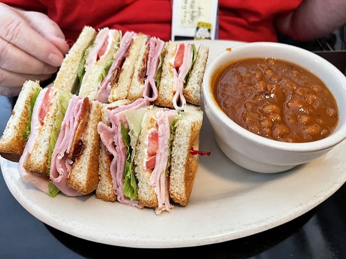 This club sandwich isn't playing around—triple-decker construction with enough layers to satisfy both your hunger and your need for sandwich engineering excellence.